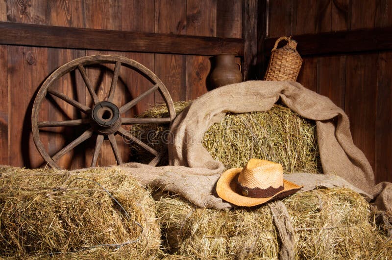 Interior of a Rural Farm - Hay, Wheel, Cowboy Hat Stock Photo - Image ...