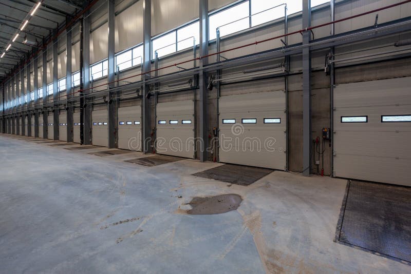Interior Shot of a Warehouse with a Large Row of Loading Doors Stock ...