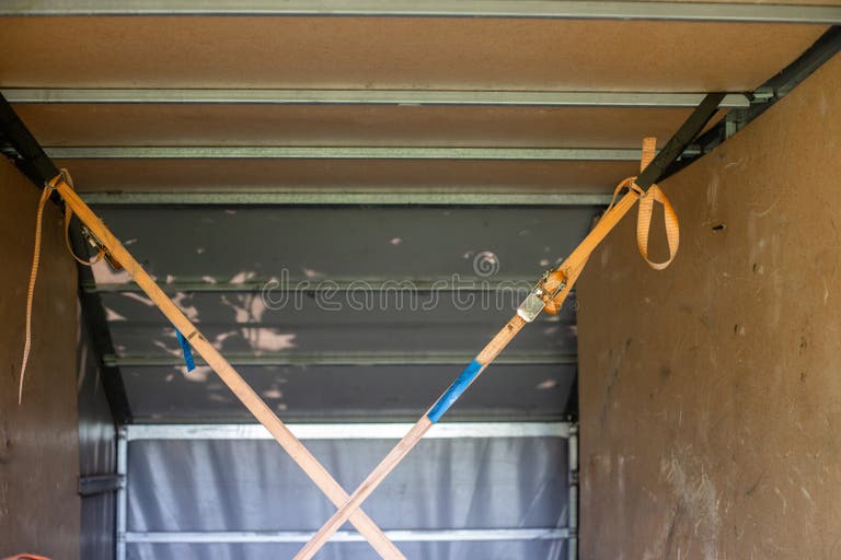 Interior View of a Cargo Hold with Tie-down Straps Stretched between ...