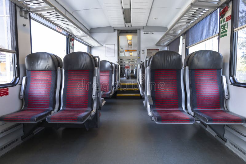 Interior View of a Modern Passenger Train with Empty Seats, Red and ...
