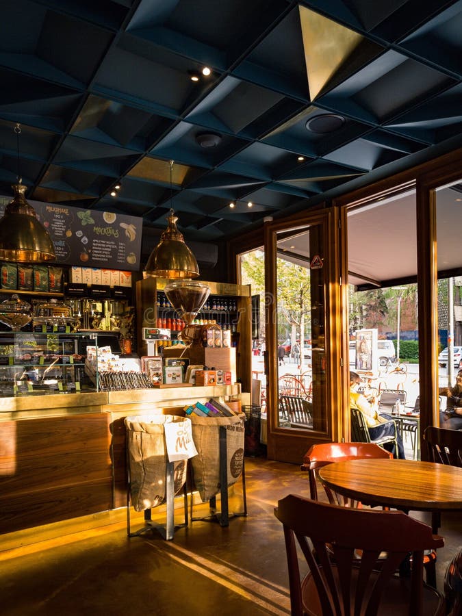 A Restaurant with Tables and Some Chairs Looking in the Window ...