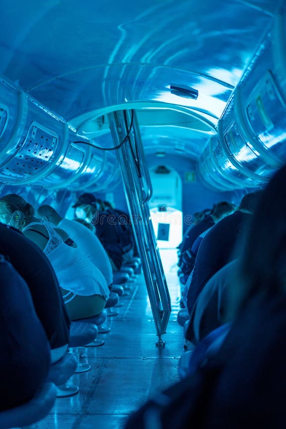 Submarine Interior with Seated Passengers Under Blue Light. Stock Photo ...
