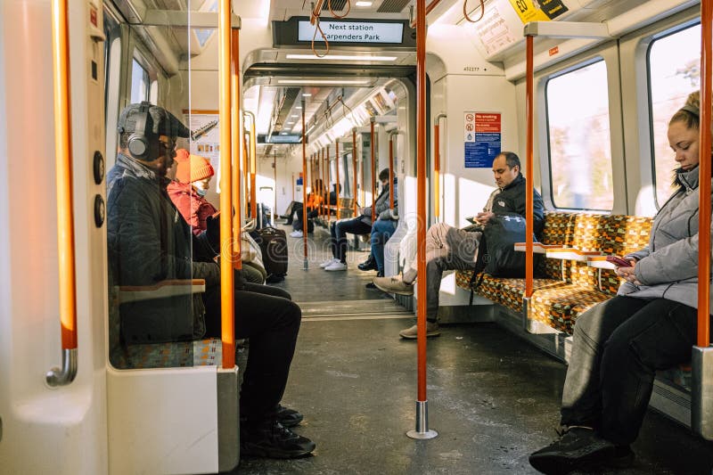 Interior View of a Subway Train with Several Passengers Seated and ...