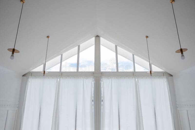 Interior View of Triangle Shape Window with White Curtain and Cloud Sky ...