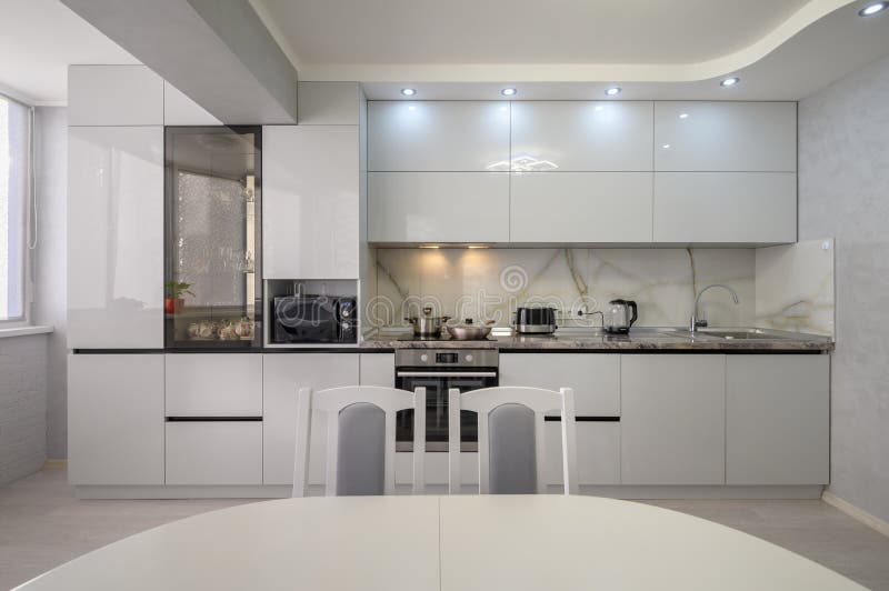 Interior of Modern Trendy White Kitchen, Front View Stock Photo - Image ...