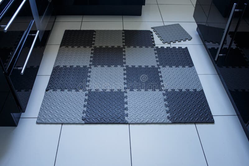 Interlocking Foam Tiles on Kitchen Floor with One Tile Removed, Showing ...