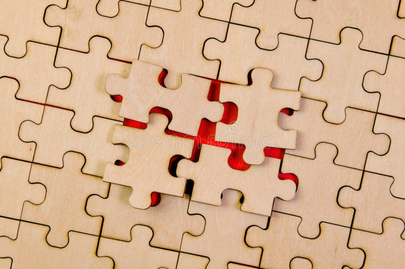 Interlocking Puzzle Pieces on Red Background: Strategy and Teamwork ...