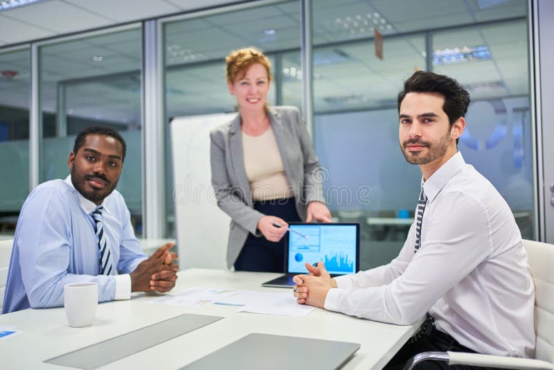 International Business Team Using Laptop in a Meeting Stock Image ...