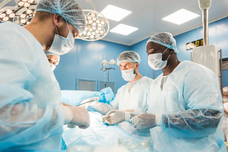An International Team of Doctors Performs a Complex Surgical Operation ...