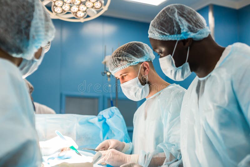 An International Team of Doctors Performs a Complex Surgical Operation ...