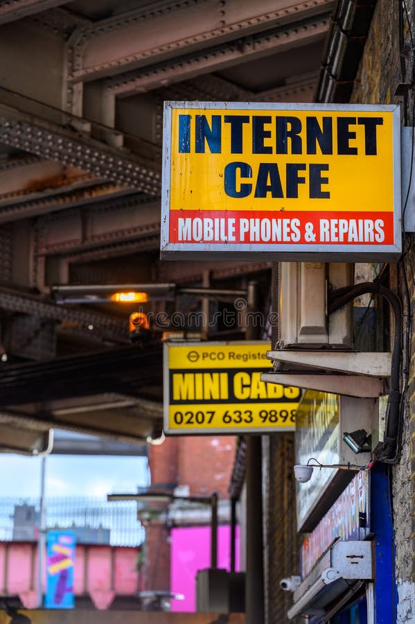 Internet Cafe and Mini Cabs Signs on Side of Building Editorial ...