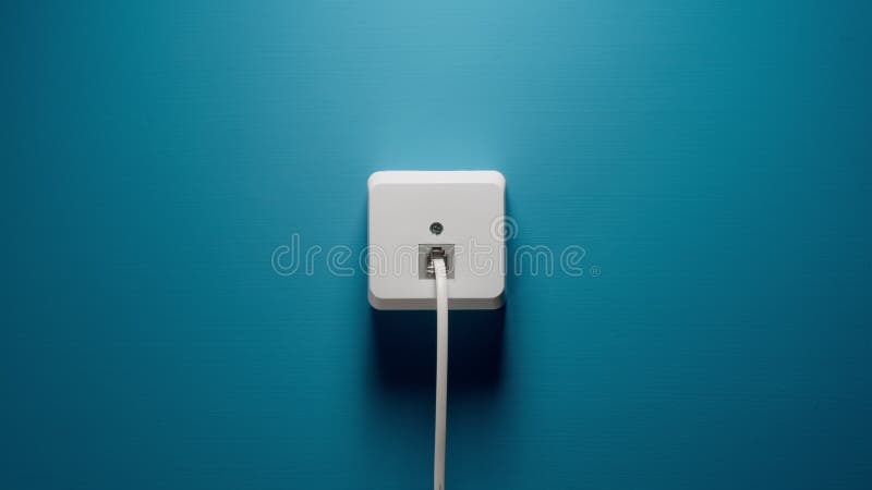 Internet Cord into Wall Socket on a Blue Wall Stock Photo - Image of ...