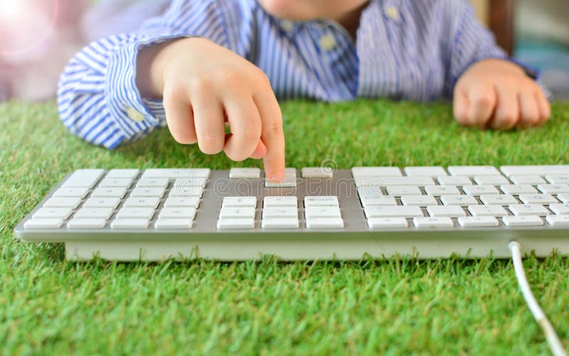 Internet Gaming and Education Concept. Baby and Computer Keyboard on a ...