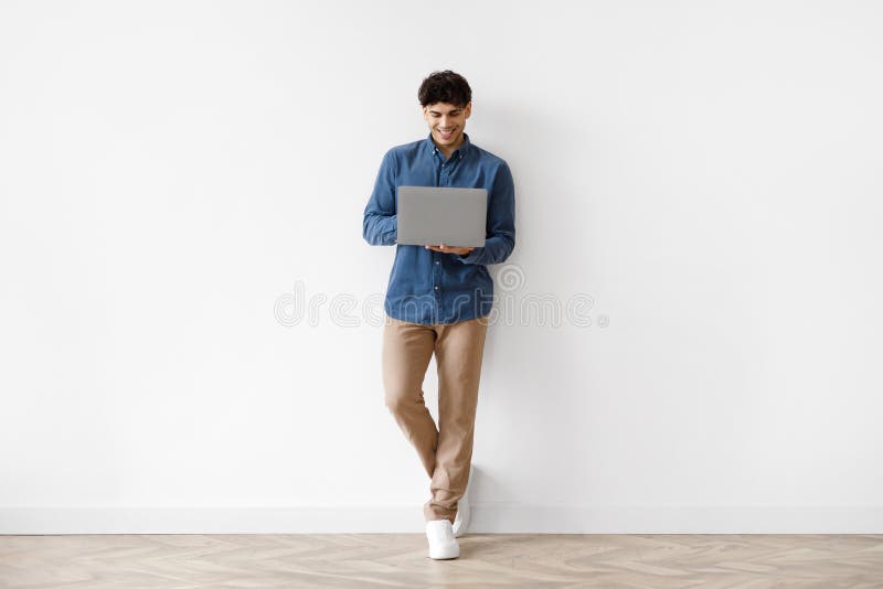 Happy Middle Eastern Freelancer Guy Using Laptop Computer Standing ...