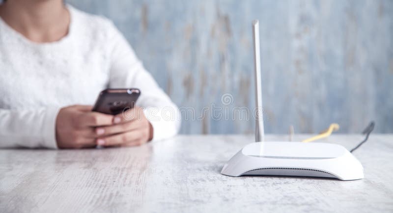 Internet Router in the Desk. Girl Using Smartphone Stock Photo - Image ...