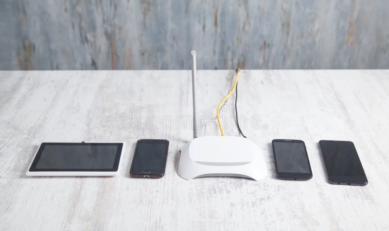 Internet Router with a Smartphones and Tablet on the Desk. Network ...