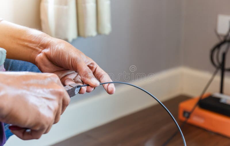 Internet Technician Man are Cutting and Installation Fiber Optic Cables ...
