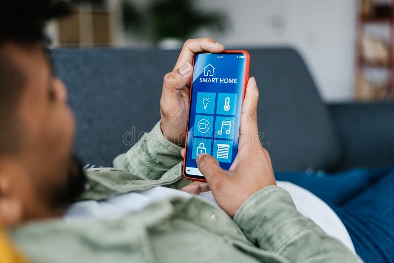 Internet of Things. Young Latin Man Using Smart Home App on Mobile ...