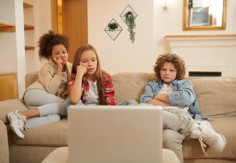 Three Kids Watching Something on a Laptop Stock Image - Image of ...