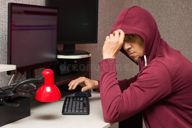 Internet Troll with the Evil Face Sitting at the Computer. Bad Man ...