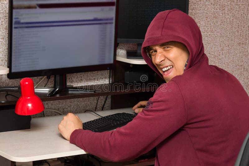 Internet Troll with the Evil Face Sitting at the Computer. Very Bad Man ...