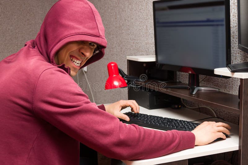 Internet Troll with the Evil Face Using a Computer. Very Bad Man Laughs ...