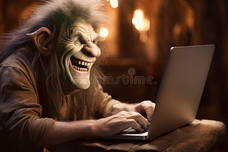 Internet Troll with Evil Mischievous Grin Typing on Laptop Computer ...