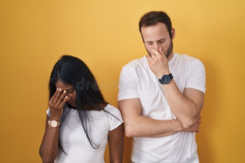 Interracial Couple Standing Over Yellow Background Smiling Making Frame
