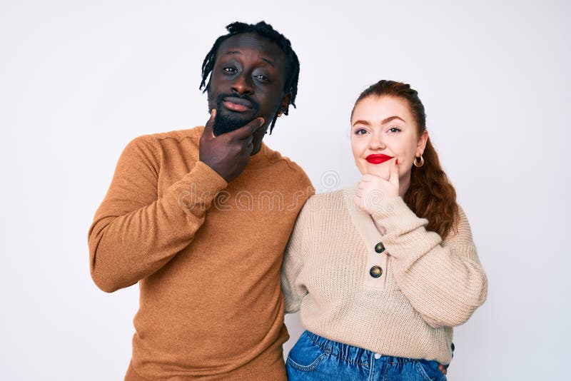 Interracial Couple Wearing Casual Clothes Looking Confident At The