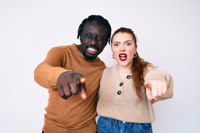 Interracial Couple Wearing Casual Clothes Pointing Displeased And