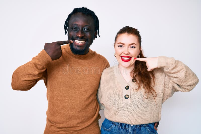 Interracial Couple Wearing Casual Clothes Smiling Cheerful Showing And