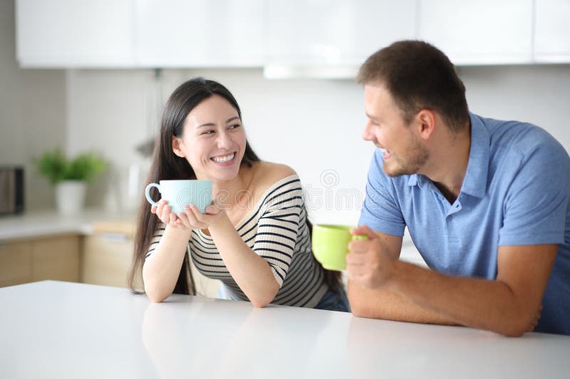 Interracial Friends Drinking and Talking in a Kitchen Stock Photo ...