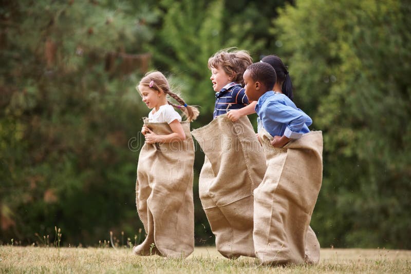 Kids at a sack race stock photo. Image of community, interracial - 87806592
