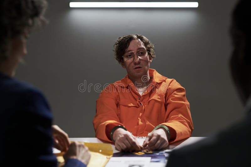 Interrogation Scene Featuring Inmate in Orange Jumpsuit Stock Photo ...
