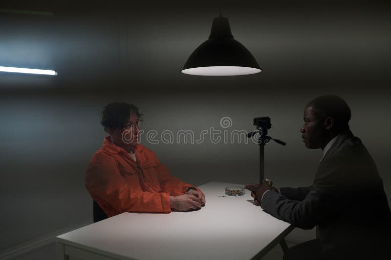 Interrogation Scene with Man in Orange Jumpsuit Stock Photo - Image of ...