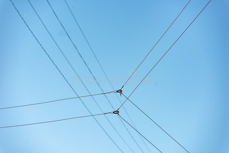 Intersecting Wires with Metal Ring Against a Blue Sky Stock Photo ...