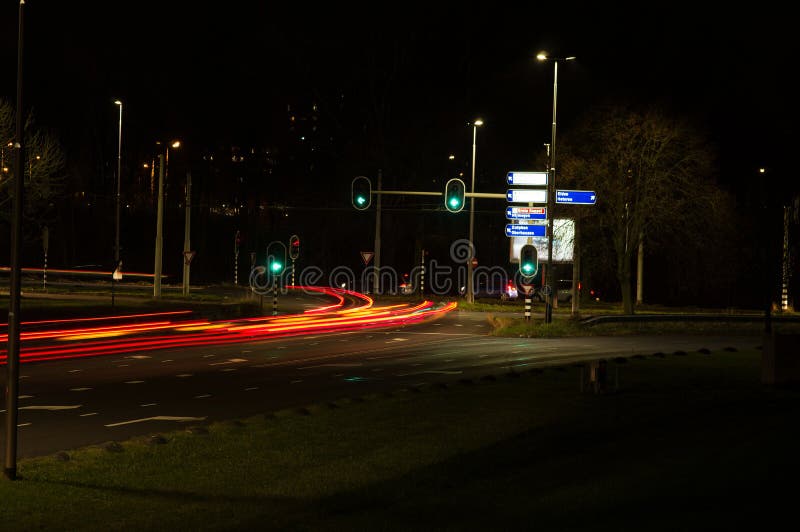 Intersection with a Row Cars at Night, Netherlands Stock Image - Image ...