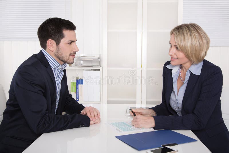 Interview with Manager and Young Attractive Man at Office. Stock Photo ...