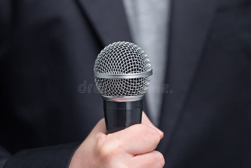 Interviewer or Reporter with Microphone in Hand in Foreground, M Stock ...
