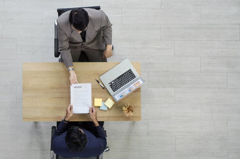 The Interviewer in a Suit Receiving Resume from Candidate during a Job ...