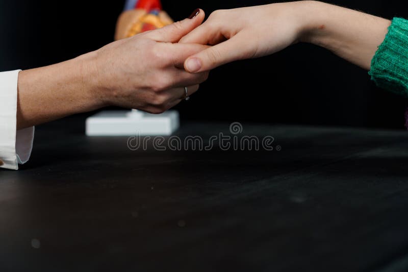 Intimate Connection: Two Hands Engaging in a Compassionate Touch Over a ...