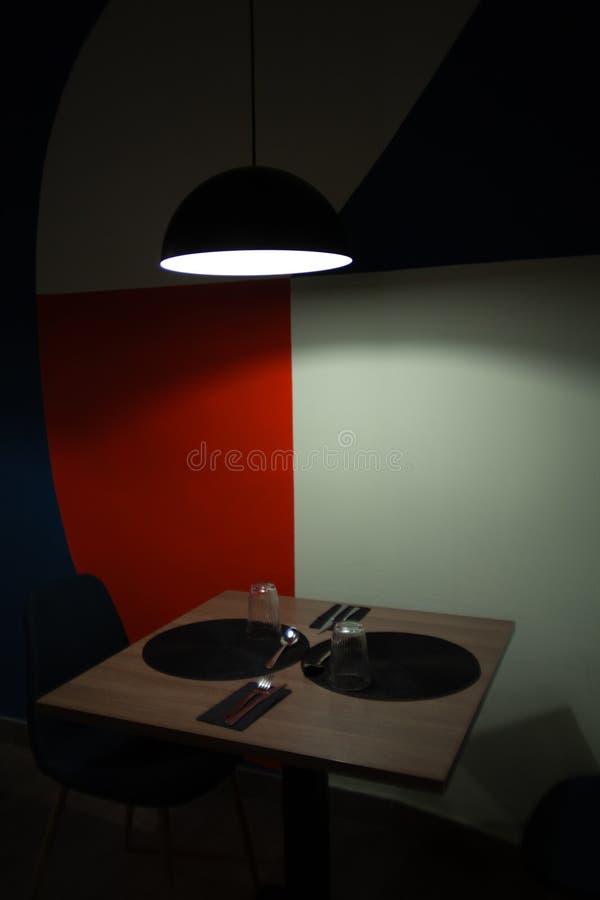 Intimate Table Setting Under Modern Light Stock Image - Image of table ...