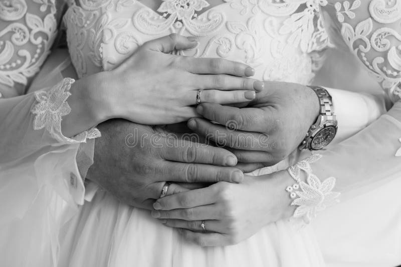 Intimate Wedding Moment: Hands Interlocked with Rings Symbolizing Love ...