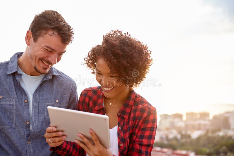 Intimate Young Couple Laughing with a Tablet Stock Photo - Image of ...