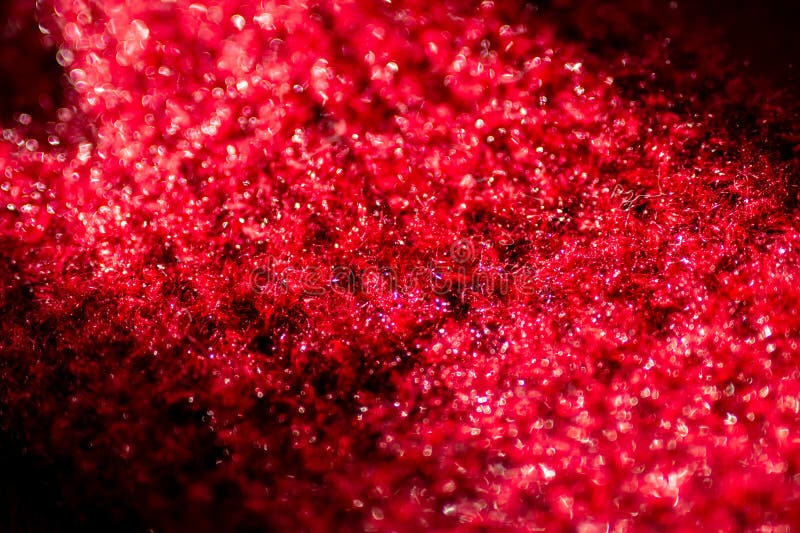 An Intricate Closeup of Vibrant Red Glitter on a Deep Black Background ...