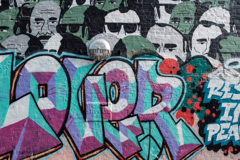 Colorful Graffiti Covers a Brick Wall, Featuring Stylized Letters in ...