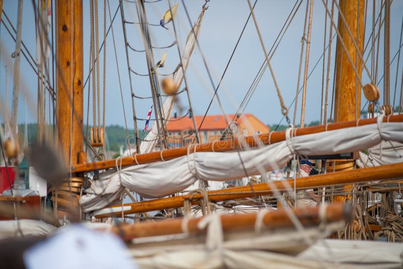 Intricate Rigging on Sailing Ship with Harbor Buildings in the ...