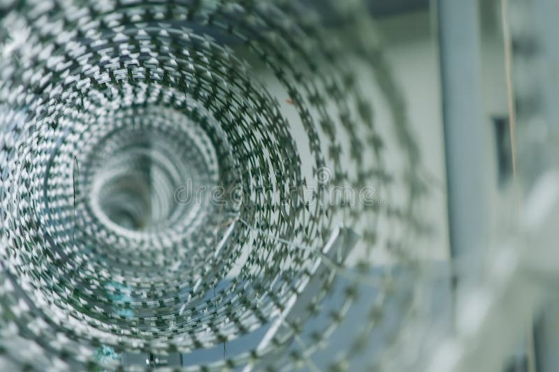 Intricate Spiral of Razor Wire with Geometric Patterns. Stock Image ...