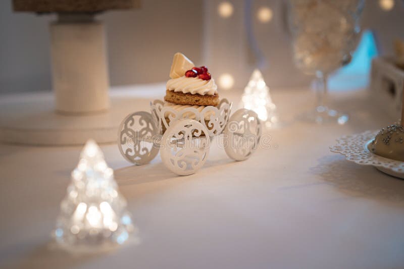 Intricate Table Setting with a Cupcake in a Decorative Carriage Wrapper ...