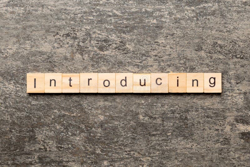 Introducing Word Written on Wood Block. Introducing Text on Table ...